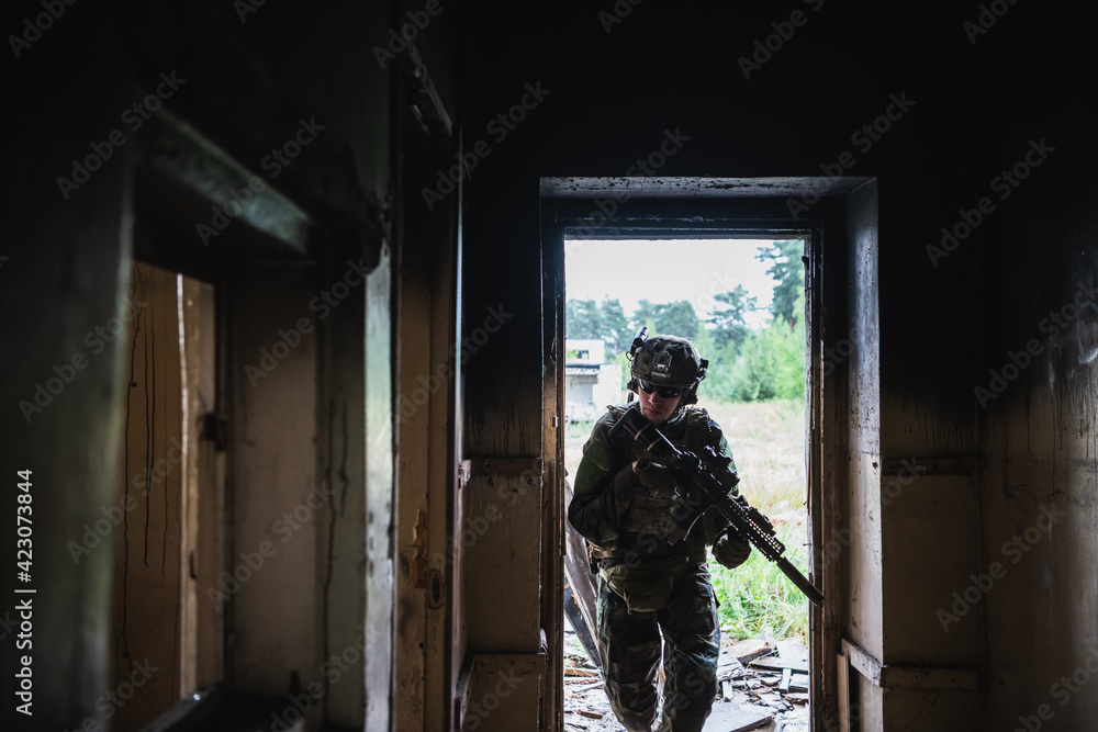 Soldier in full US MARSOC armed with assault rifle run through the ...