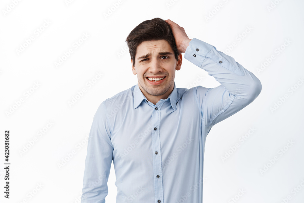 Nervous male office manager making mistake, look upset, touch head ...