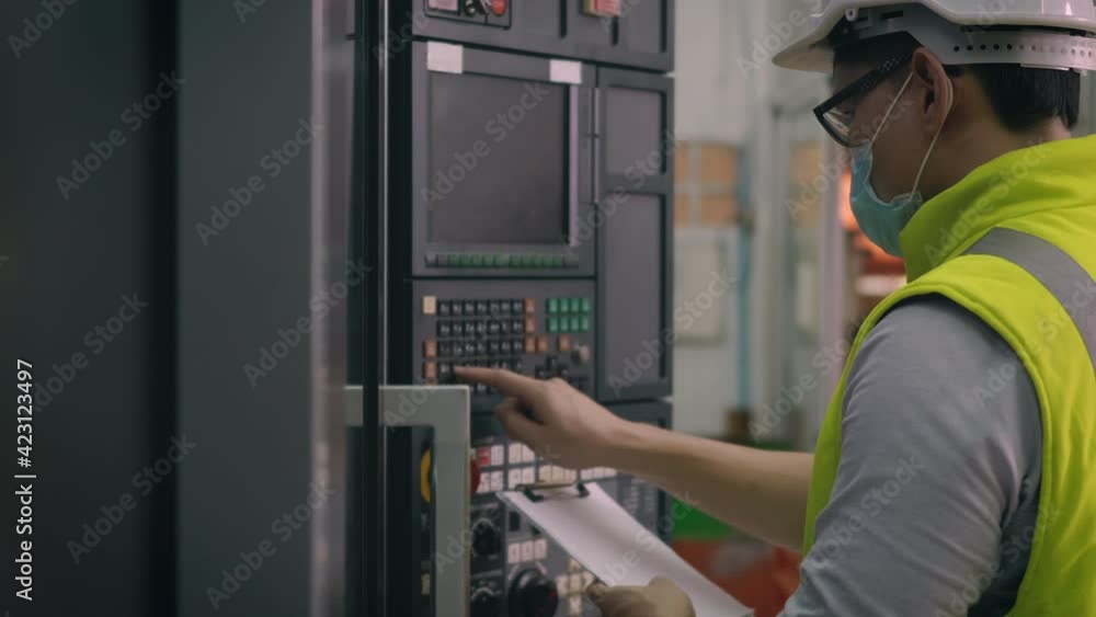 Asian factory worker man operating automated programming CNC milling ...