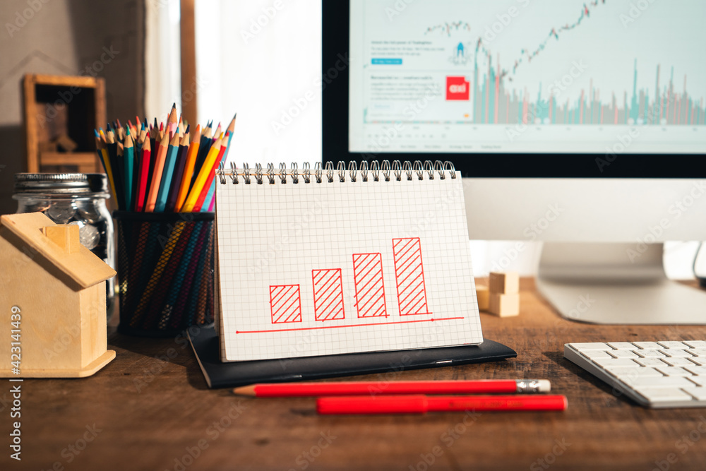 Drawing a graph of growth in a notebook on your desk at home. Stock ...