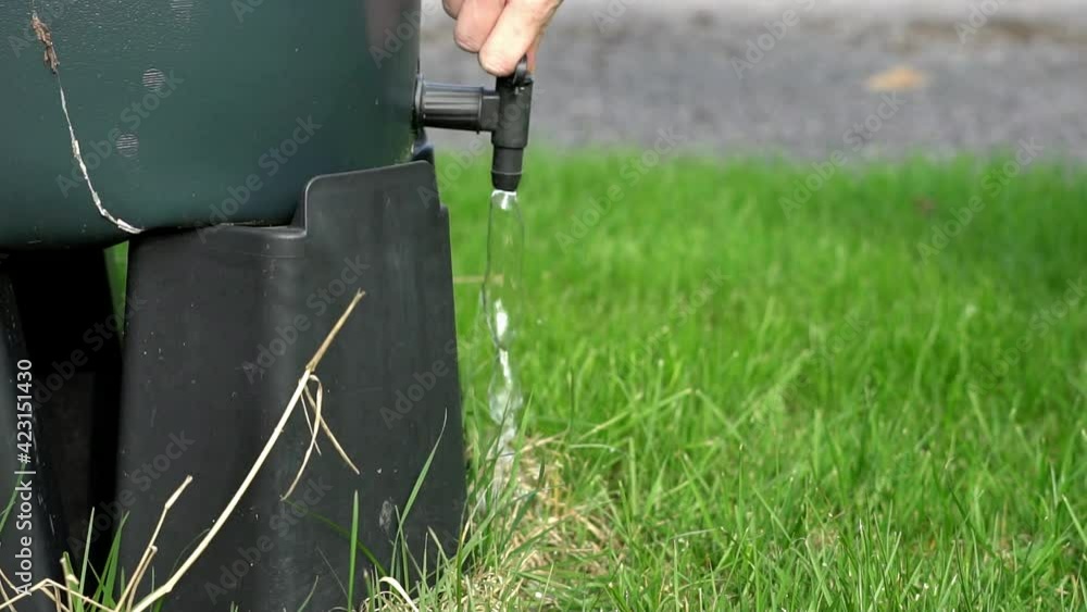 Outside water tap in side on view running water in slow motion. Water ...