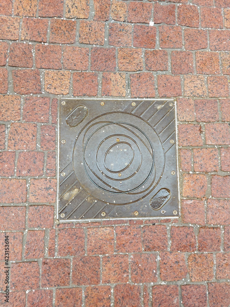 red brick with cast iron manhole cover. Stock Photo | Adobe Stock