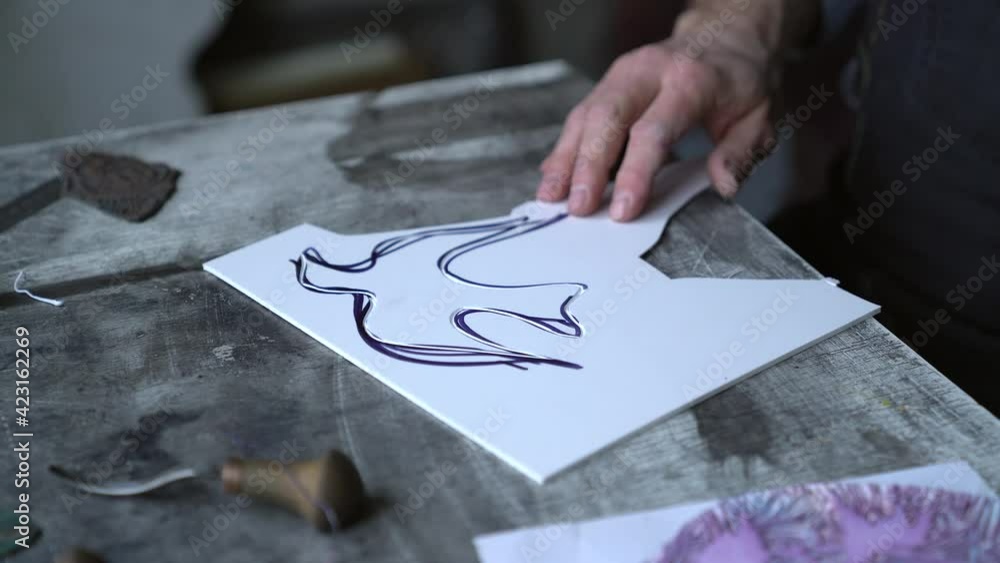 Linocut artist making handmade carving process. Professional lithograph ...