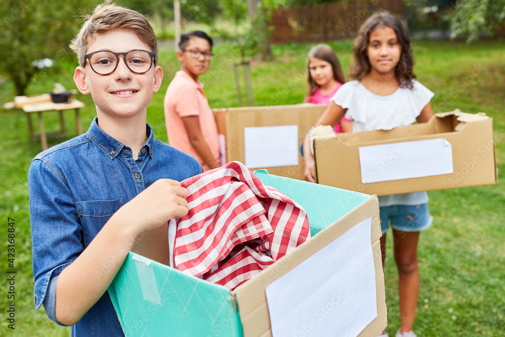 Children at fundraising with clothing donations Stock Photo | Adobe Stock