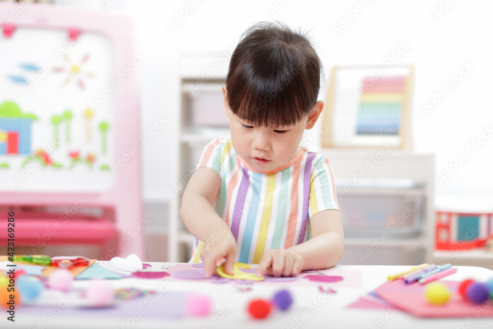 young girl making paper craft for homeschooling Stock Photo | Adobe Stock