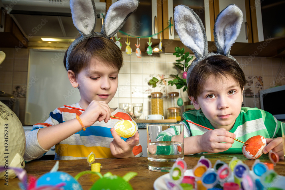 Two kids, happy boy and his cute toddler brother, having fun together ...