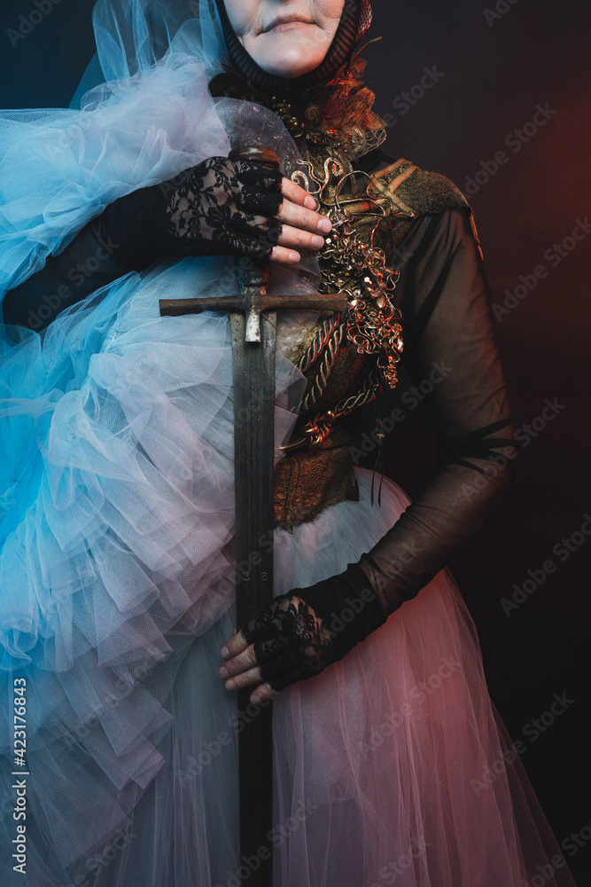 Female hands holding a sword, cropped photo. Fabulous creature ...