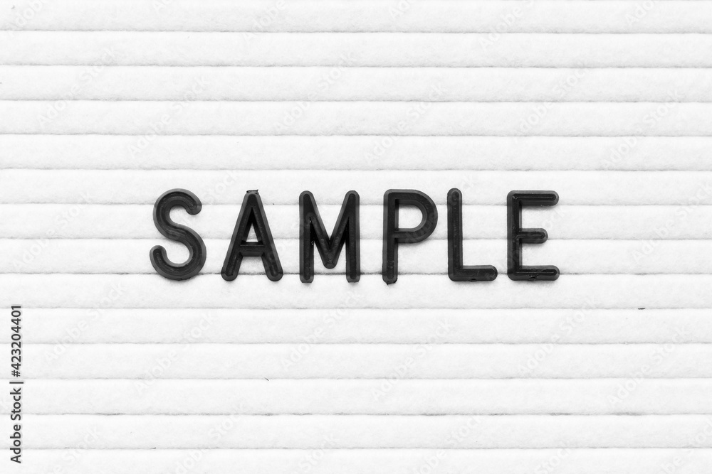 Black color letter in word sample on white felt board background Stock ...
