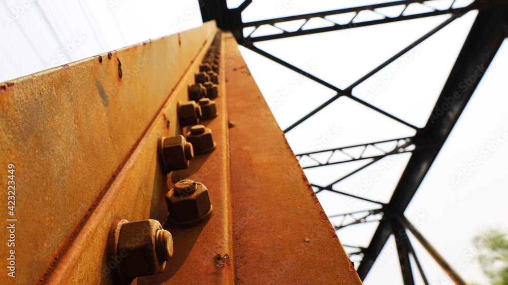 Rusted nuts and bolts on the old bridge. On the reddish-brown steel ...