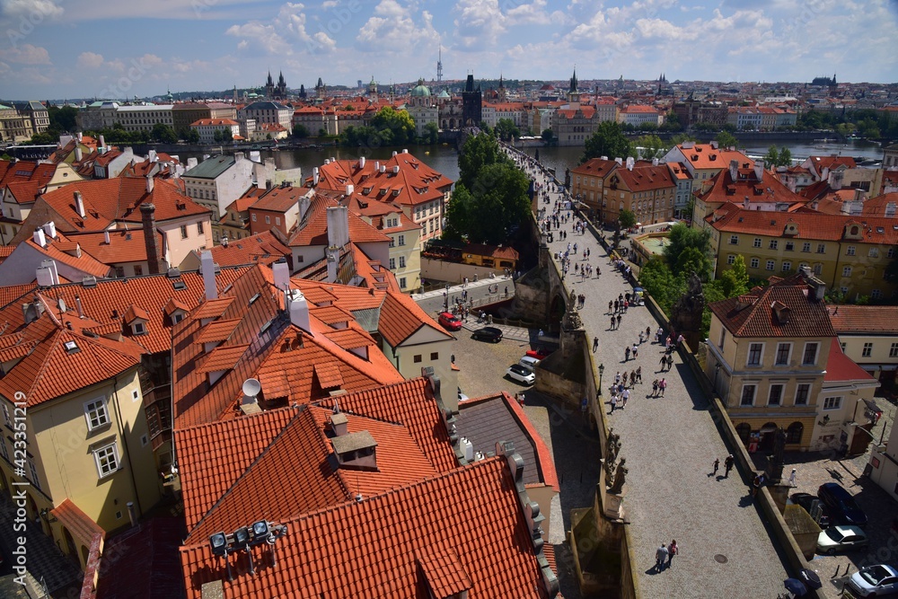 Prague is characteristic with its red rooftops, here shown in summer ...