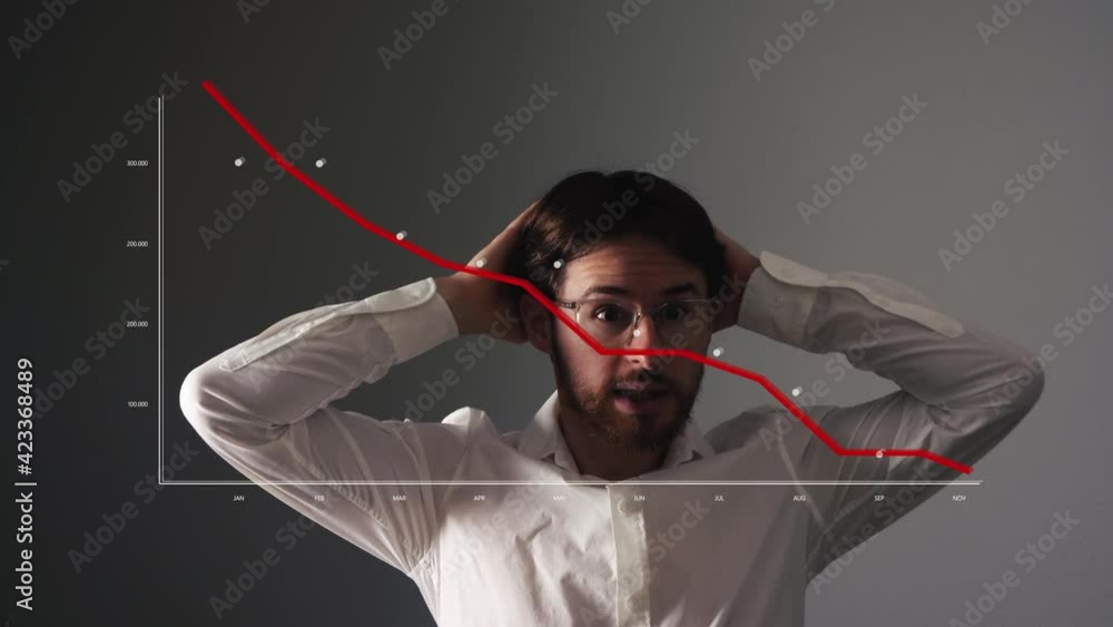 Vidéo Stock Young businessman looks scared at graph with red falling ...