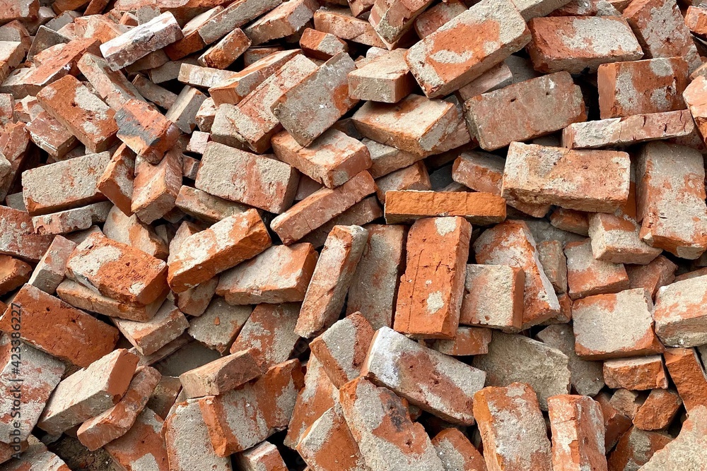 Details closeup of a stack of waste red building bricks background ...
