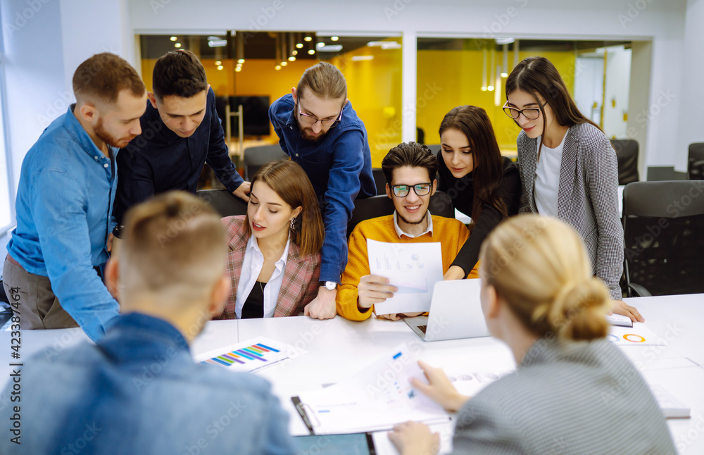 Group of young businesspeople working together in creative office ...