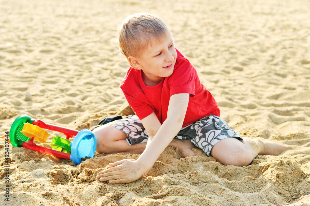 boy playing sand Stock Photo | Adobe Stock