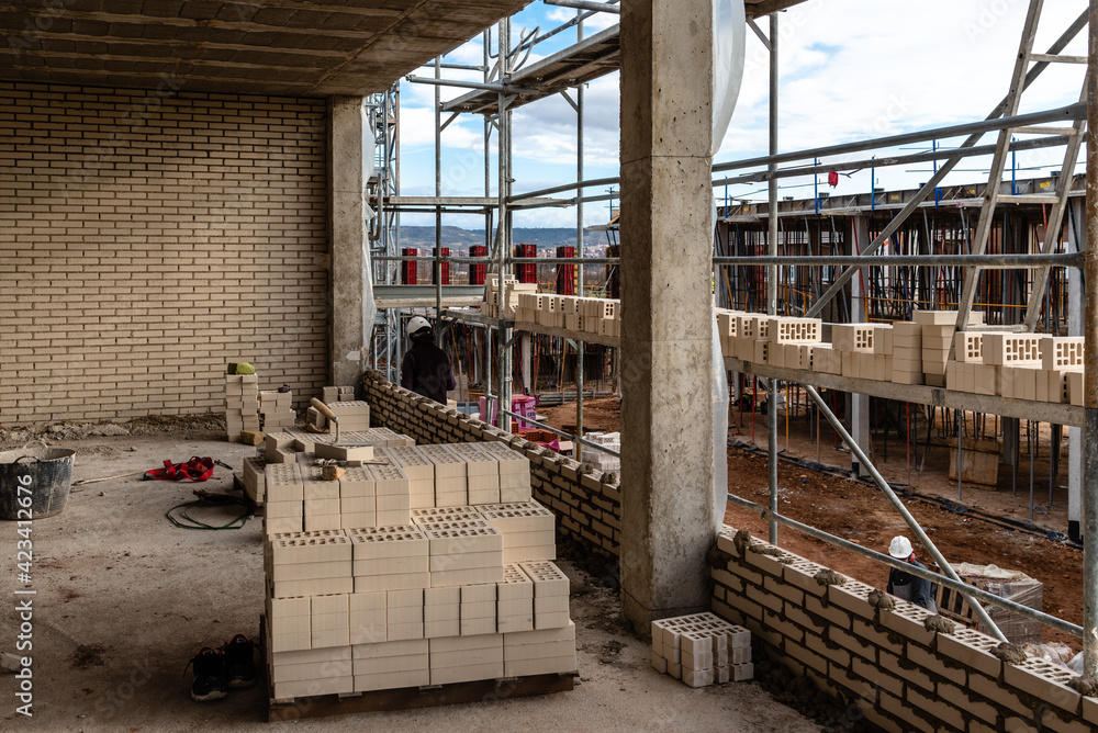 Bricks on scaffolding ready to be placed in the construction of a ...