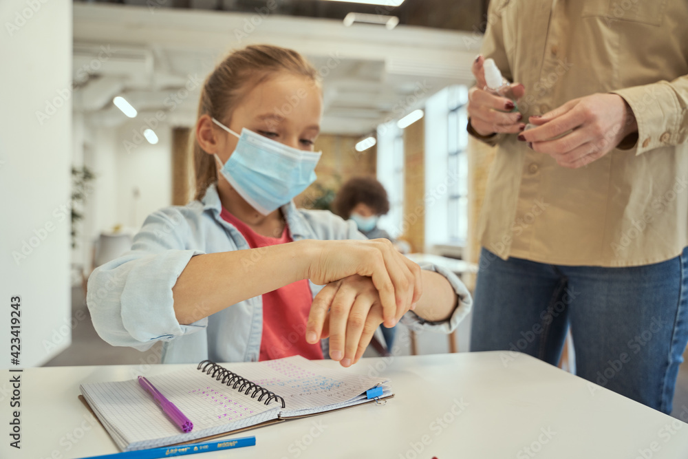 Safety rules. Close up of clean hands of little school girl wearing ...