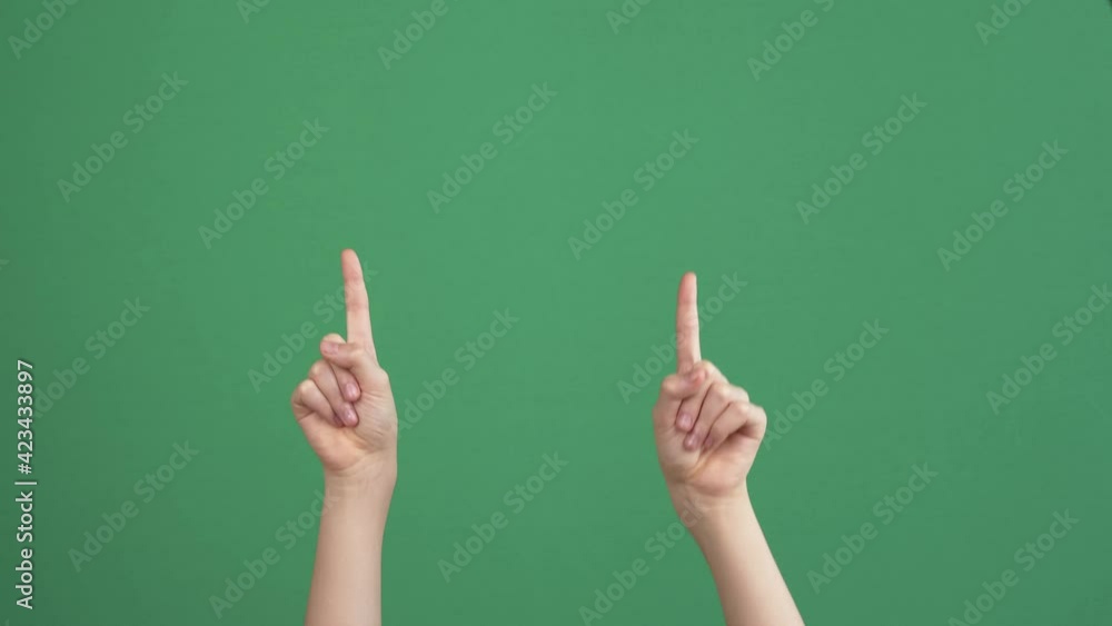 Kid hands raising up and fingers pointing up over empty chroma key ...