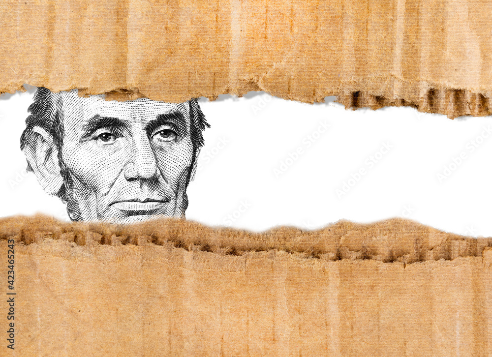 President Abraham Lincoln $5 through ripped cardboard Stock Photo ...