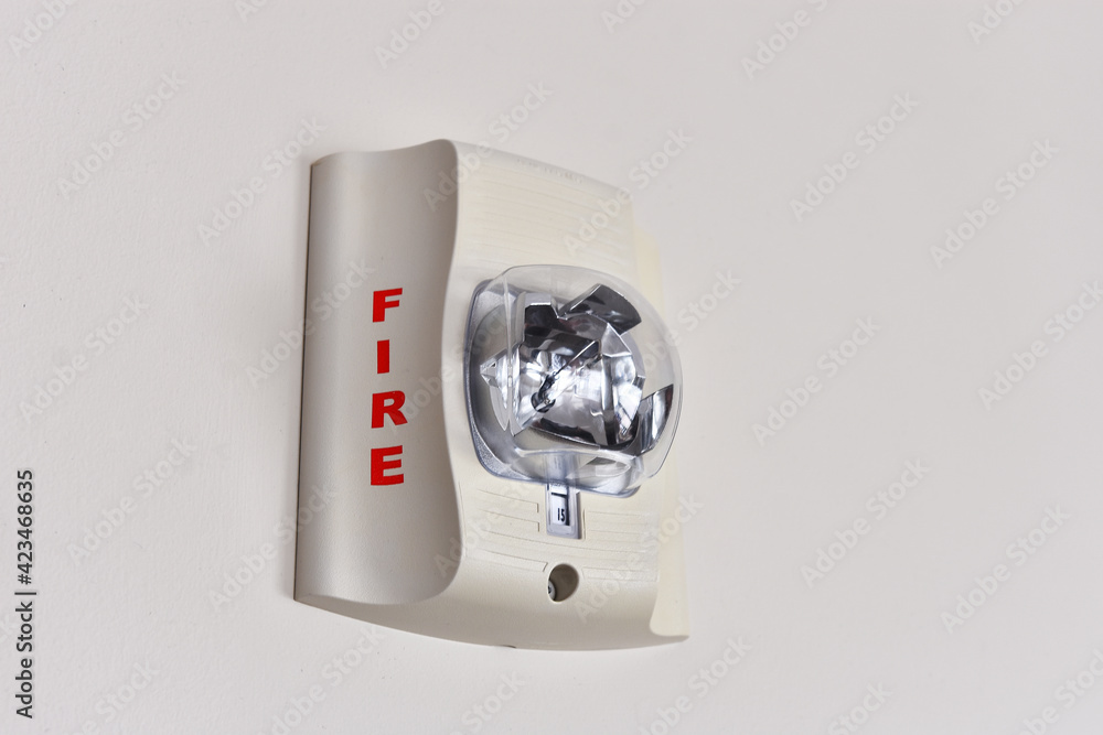 An image of a white wall mounted fire safety alarm on a white wall ...