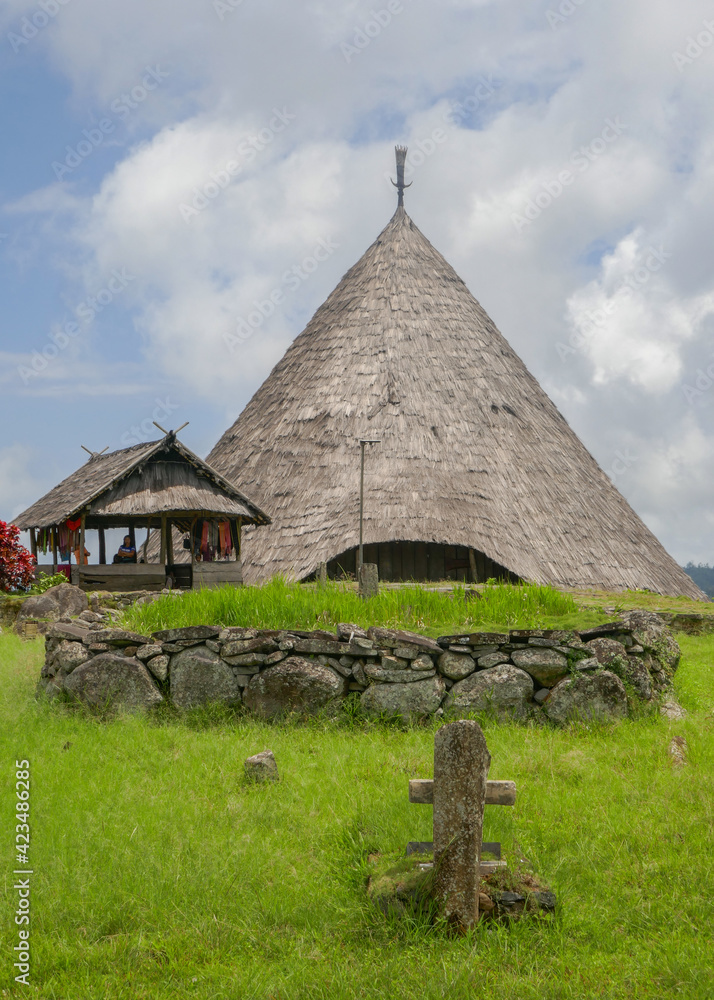 Beautiful traditional house with grave and ritual area in foreground ...
