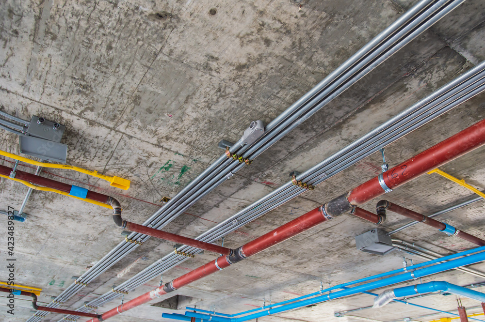 Fire sprinkler system with red pipes is placed to hanging from the ...