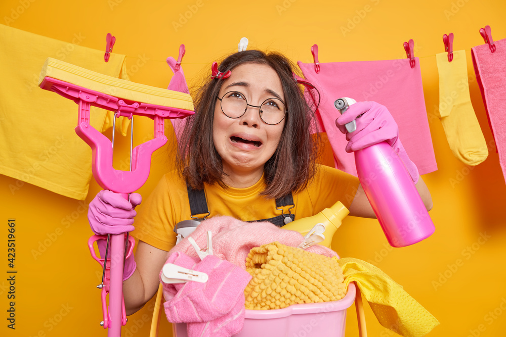 Overworked housewife feels tired of housework cries from despair wears ...