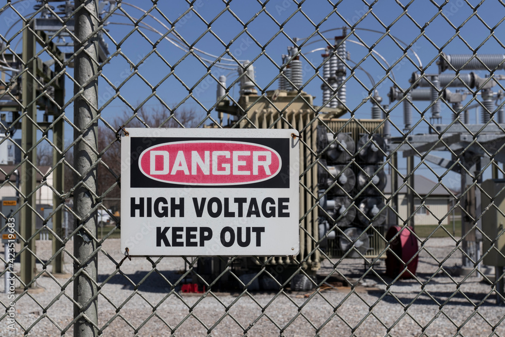 Danger - High Voltage Keep Out sign in front of an electric company ...