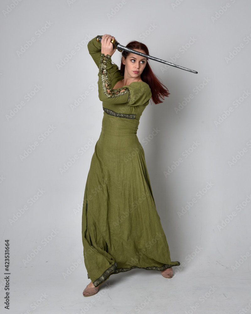 full length portrait of red haired girl wearing celtic, green medieval ...