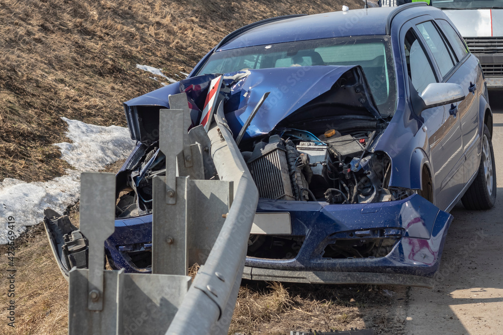 street lighting. the blue car crashed into a metal fence. Close-up ...
