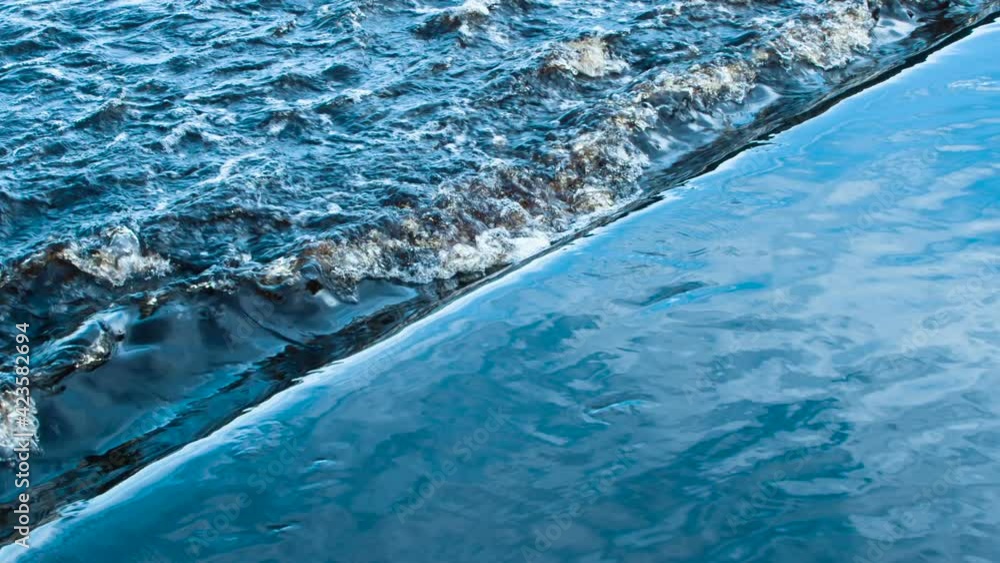 Diagonal Flow. The smooth flow of water turns into a seething splitting ...