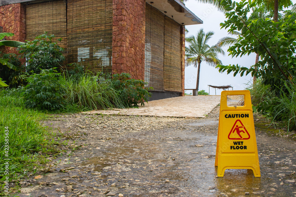 Warning yellow sign with text Wet floor and Caution. Outdoor caution ...