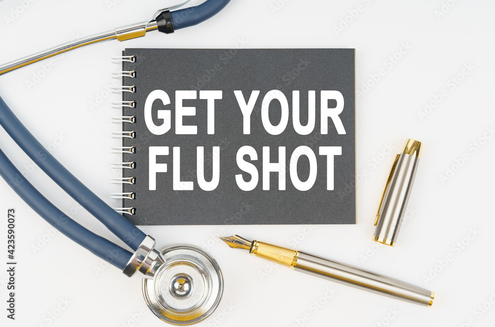 On a white background lie a stethoscope, a pen and a notebook with the ...