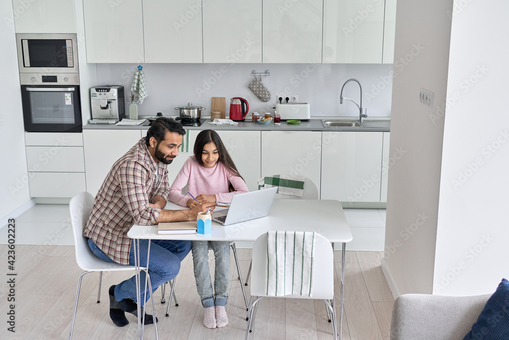 Happy young indian parent father helping teenage child daughter ...