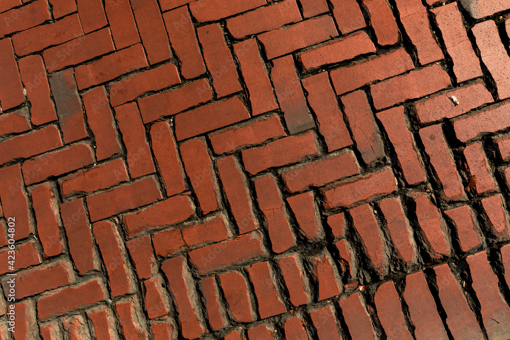 Old weathered and broken chipped brick road from naturally shiny brick ...