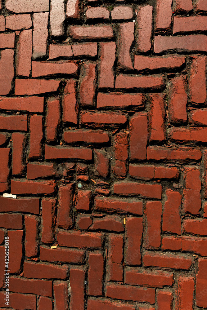 Old weathered and broken chipped brick road from naturally shiny brick ...