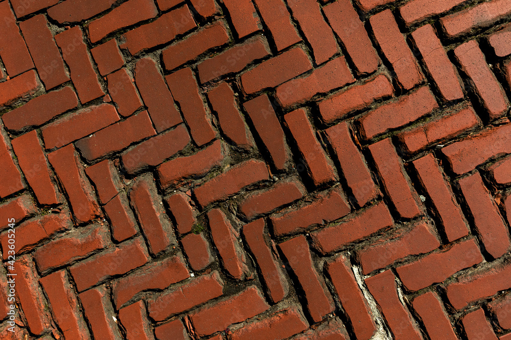 Old weathered and broken chipped brick road from naturally shiny brick ...