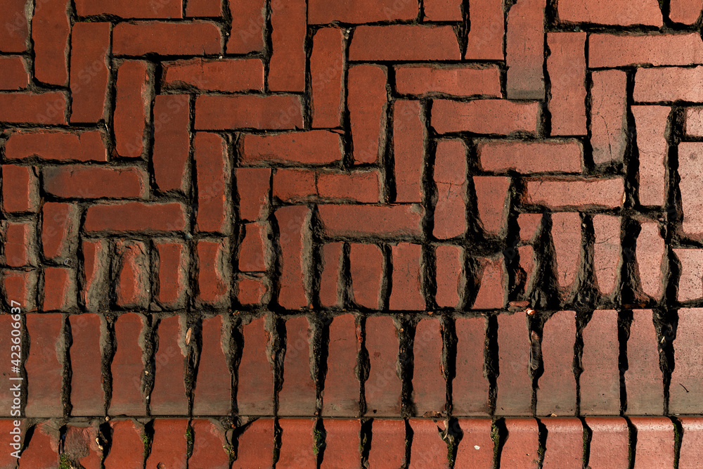 Old weathered and broken chipped brick road from naturally shiny brick ...