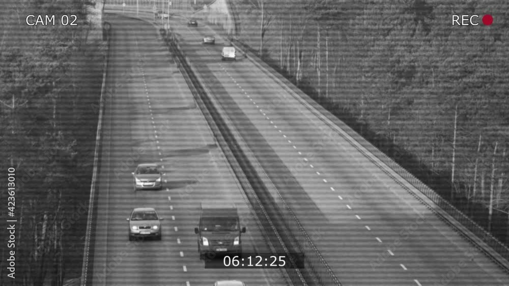 CCTV Security Camera view of Cars Driving Highway Overpass In Forest ...