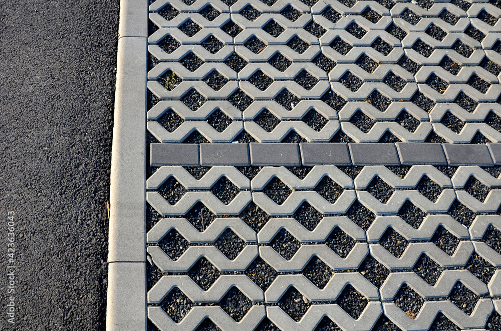 new infiltration parking lot made of porous concrete tiles in a regular ...