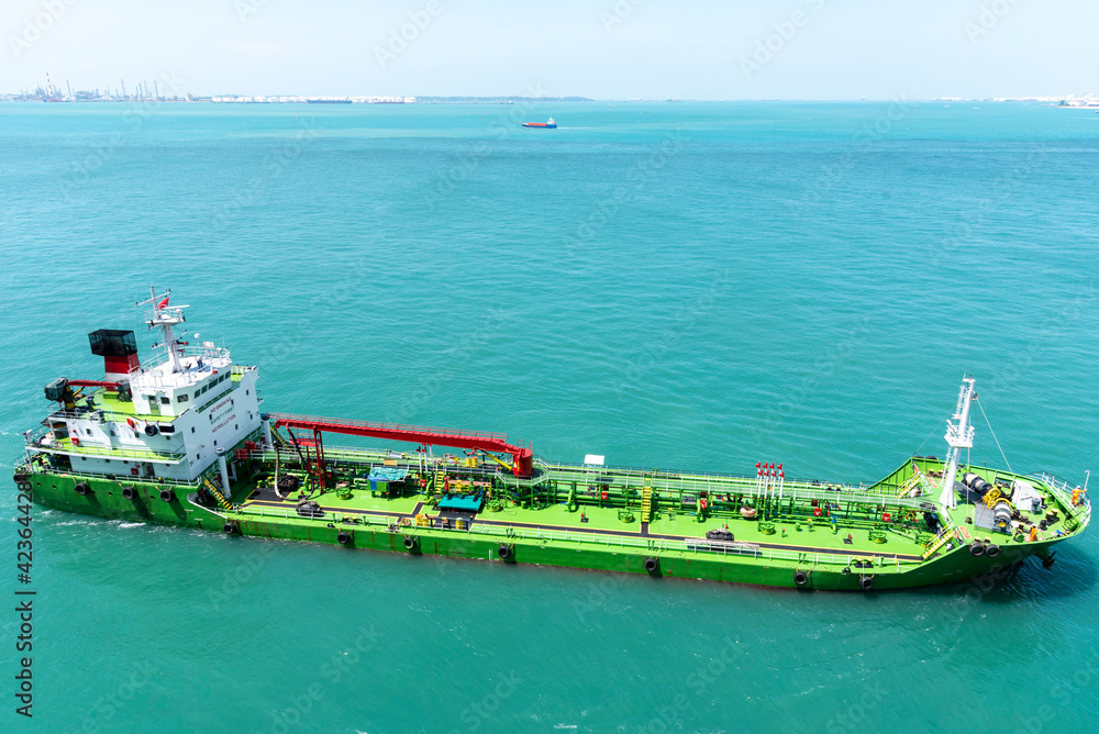 Port of Singapore, bunker barge on her way to supply fuel oil to large ...