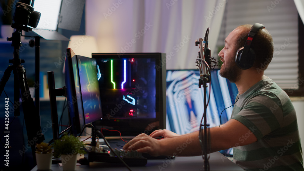 Professional digital player with headphones streaming video game with ...