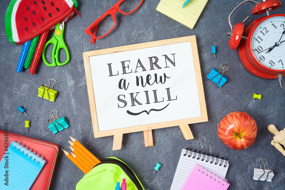 Learn new skill text with school supplies on desk. Business concept of ...