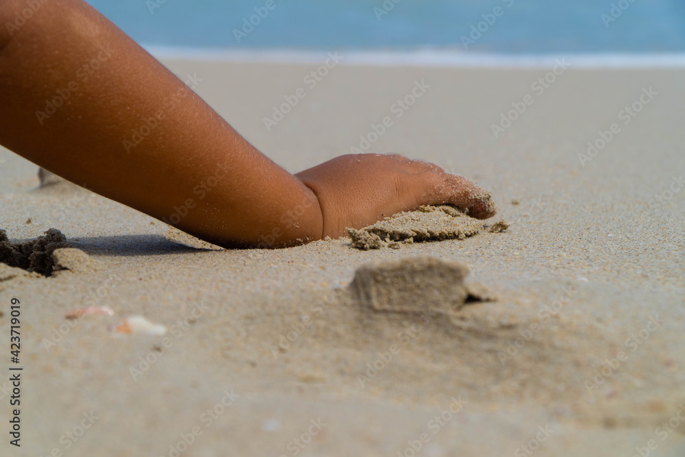 boy's hand on beach while playing in the send Stock Photo | Adobe Stock