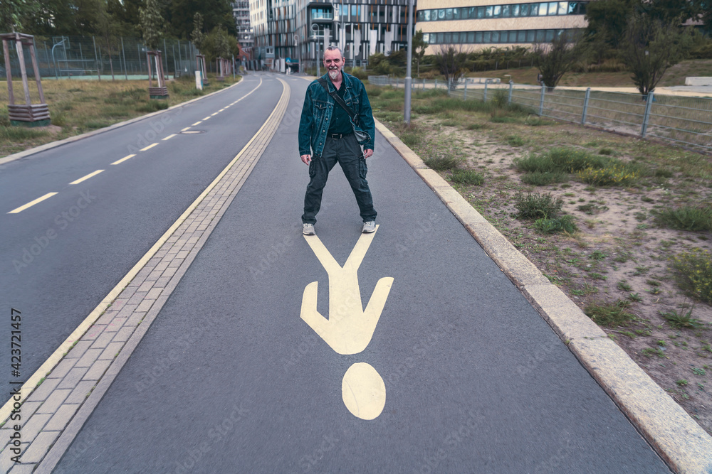 laughing, older man stands on a pedestrian sign Stock Photo | Adobe Stock