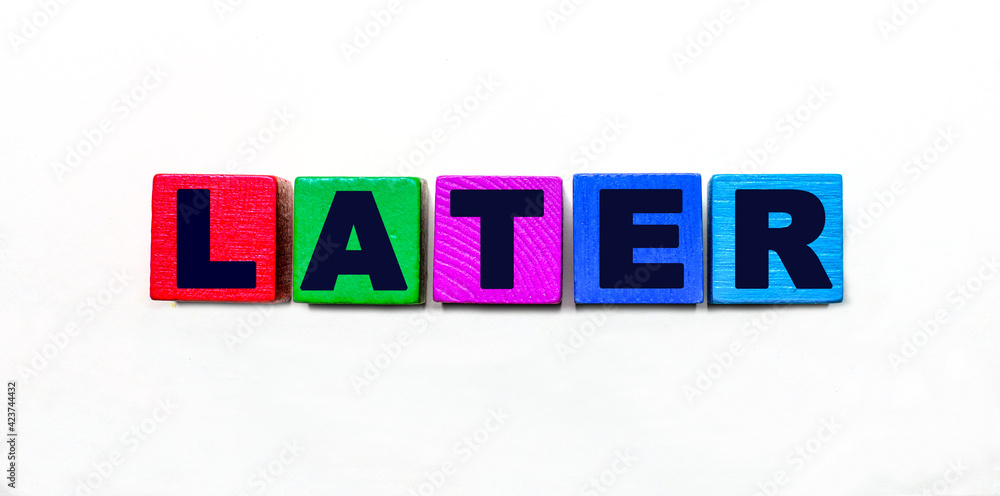 The word LATER is written on colorful cubes on a light background Stock ...