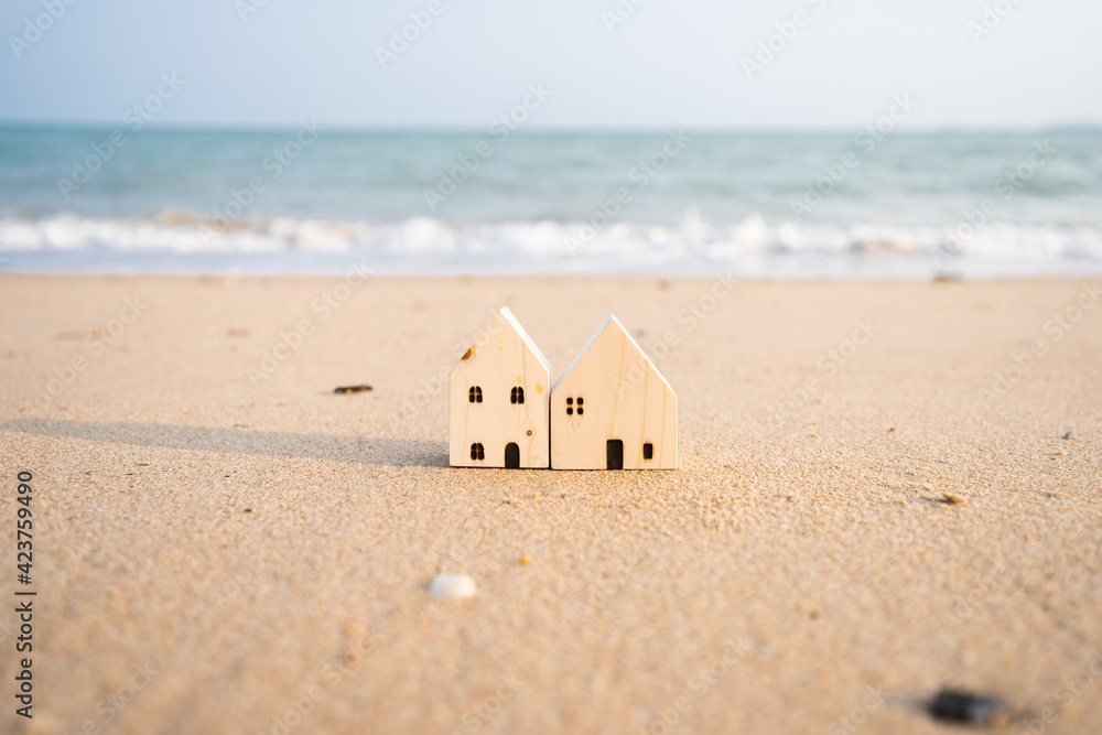 Model house on the beach, wave and sea background, real estate business ...