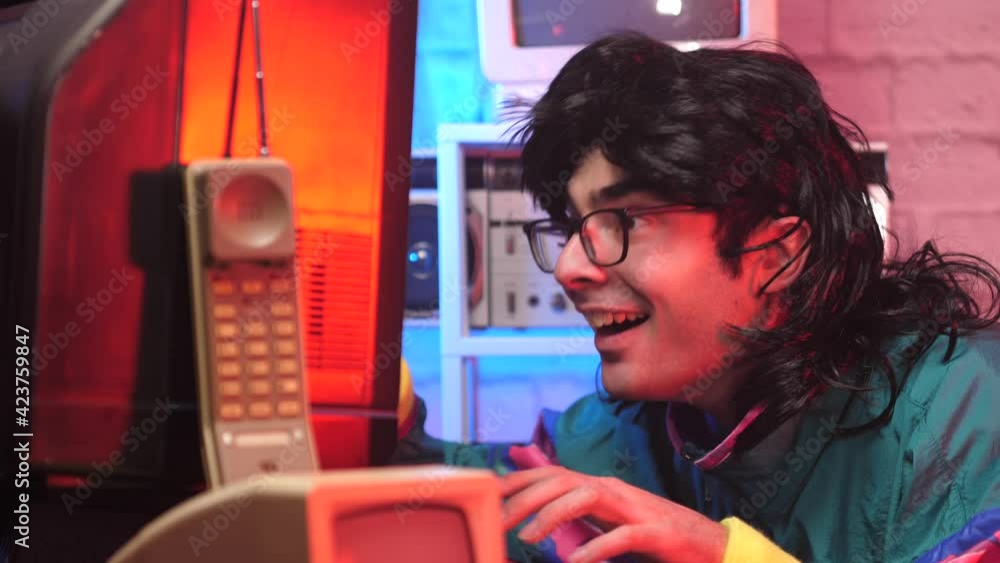 Happy retro looking man excited in front of his vintage computer screen ...