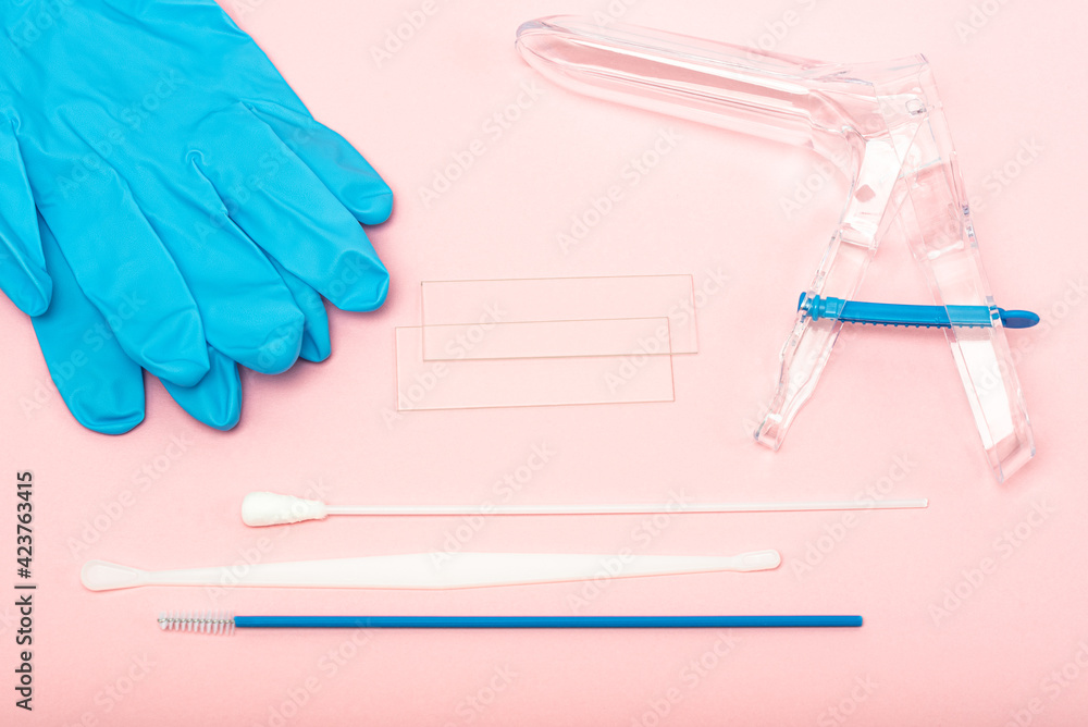Disposable gynecological examination kit on a pink background ...