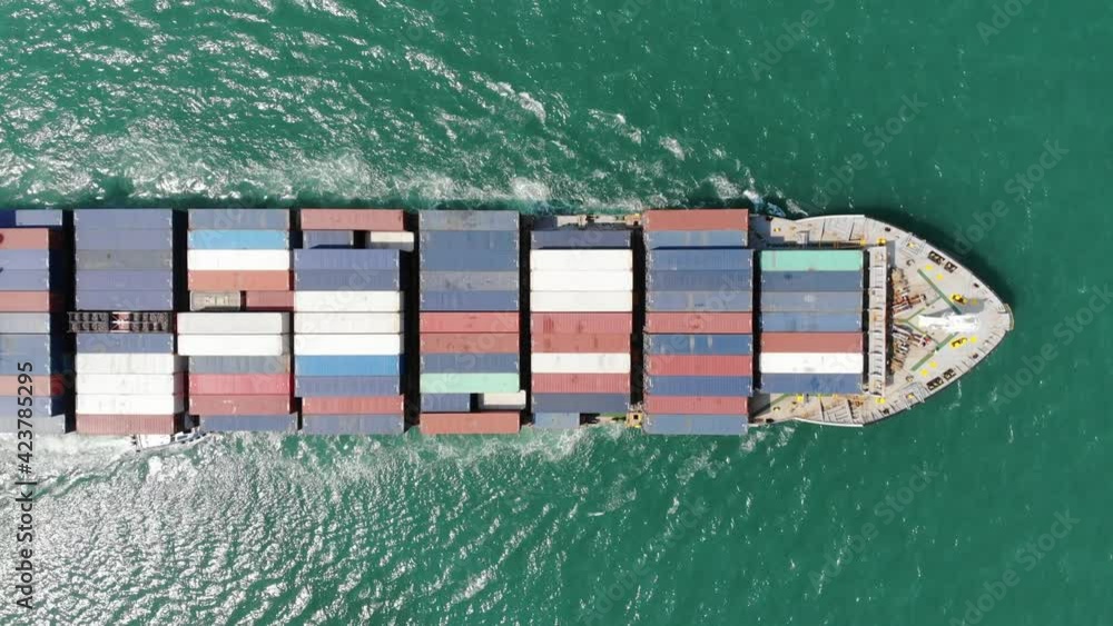 Aerial top view of smart cargo ship carrying container and running very ...