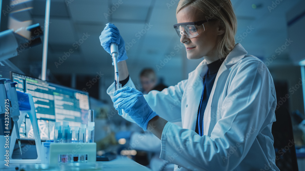Female Research Scientist Uses Micropipette to Mix Liquids in a Sample ...